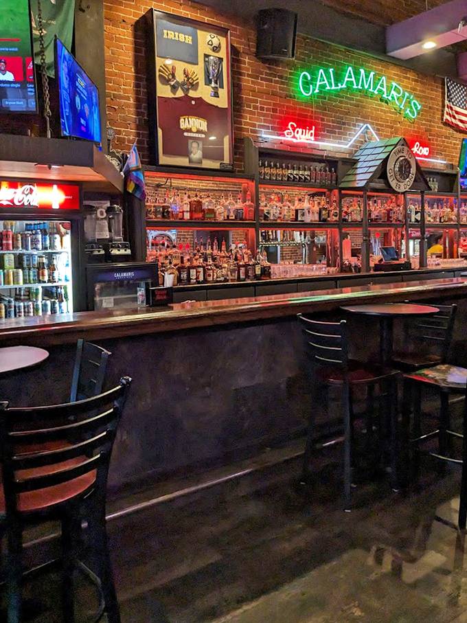 The bar beckons with its neon glow, promising cold drinks and warm conversation under the watchful eye of that famous squid.