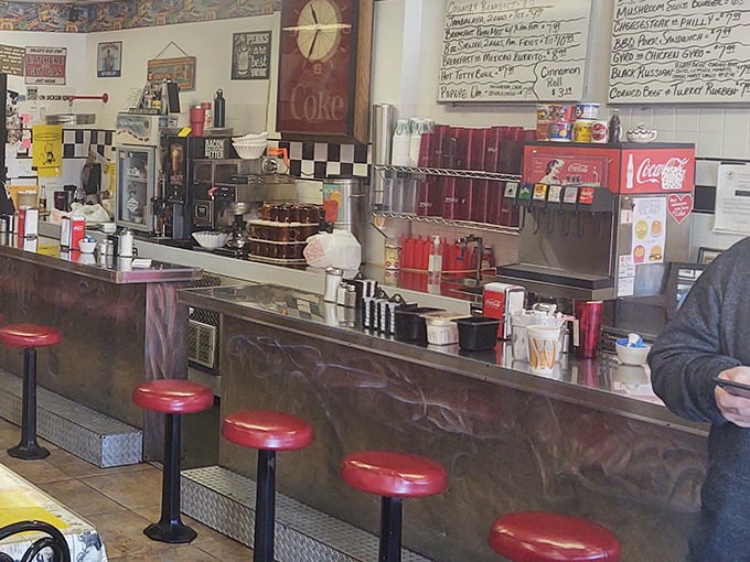 Classic diner counter seating &ndash; where solo diners become temporary neighbors and coffee cup emptiness is merely theoretical.