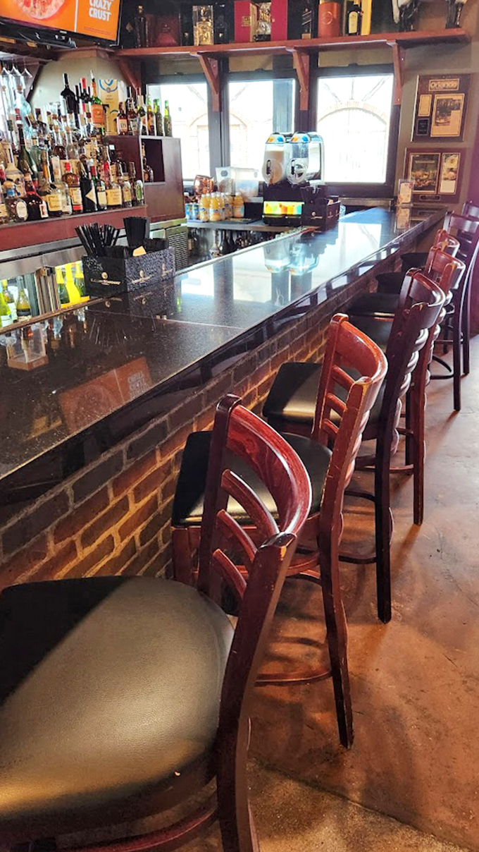 The bar stands ready for the evening's libations, its wooden stools awaiting patrons who'll soon discover that ouzo makes everyone a better Greek dancer.