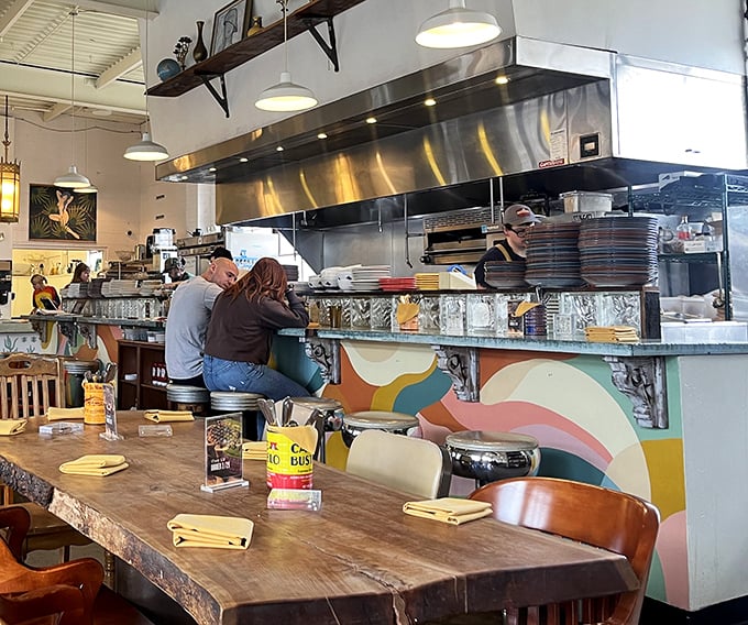 The colorful counter mural adds playful energy to serious cooking, like the culinary equivalent of wearing fancy socks with your business suit.