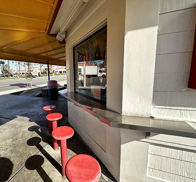 Red stools lined up like loyal soldiers awaiting your command. The counter service window&mdash;where magic happens with minimal fanfare.
