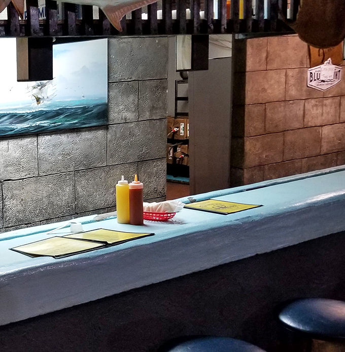 The blue counter&mdash;where oyster magic happens. This is the front-row seat to culinary theater, where skilled hands transform rough shells into briny delights.