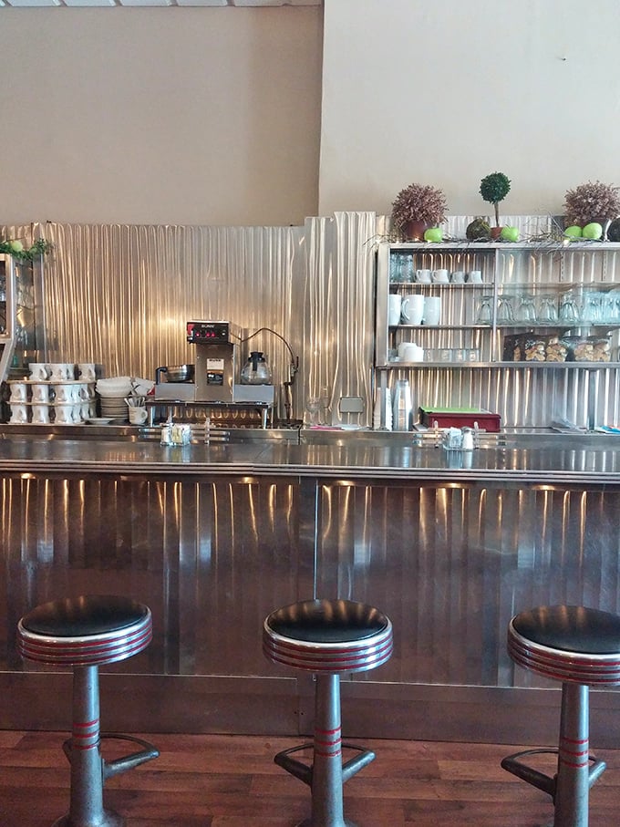 The counter area gleams with stainless steel nostalgia, where coffee cups are always full and the staff knows the regulars by name.