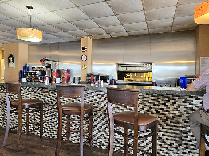 The counter where regulars become family and first-timers become regulars. Notice the checkered pattern &ndash; like a finish line for hunger.