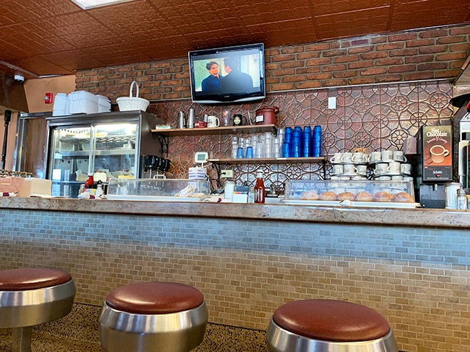 Counter seating: where solo diners become temporary members of the breakfast club. The brick wall backdrop adds that perfect touch of diner authenticity. 