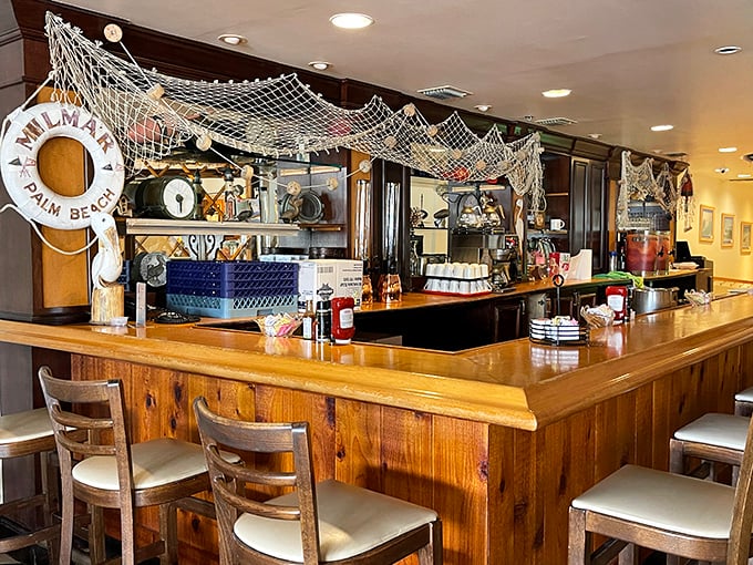 The counter seating area with its nautical touches says, "Yes, we're serious about seafood." That fishing net isn't just decor—it's a promise.