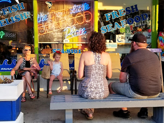 The outdoor seating area where strangers become friends, united by the universal language of "Did you try the grouper yet?"