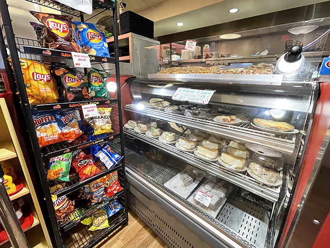 The dessert case stands guard like a sentry of sweetness, promising the perfect finale to your deli feast &ndash; calories worth every smile.