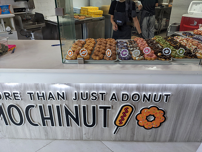 The display case: where donut dreams come true and willpower goes to die. Each tray offers a different path to happiness.