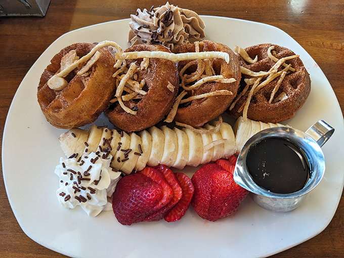 Cinnamon-dusted donuts arranged like a sweet crown, surrounded by fruit courtiers and a syrup scepter fit for breakfast royalty.