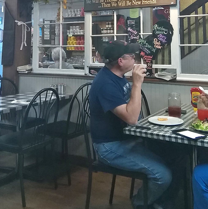 A patron enjoys his meal in peaceful solitude &ndash; the universal dining position of someone who has discovered food worth savoring without distraction.