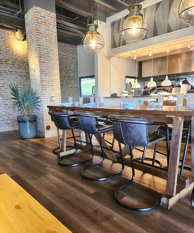 Communal dining with industrial chic appeal. That wooden table has probably witnessed more food epiphanies than a cooking show judge.