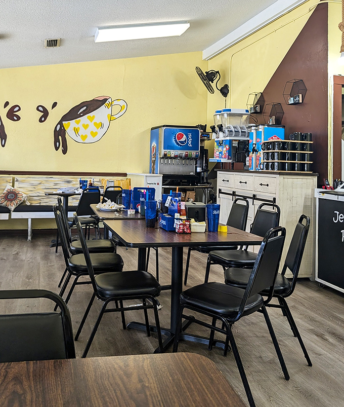 Yellow walls adorned with coffee cup art create the cheerful backdrop for countless morning conversations. Simplicity never goes out of style.