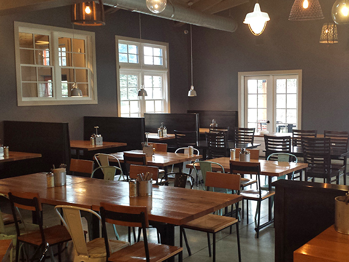 Morning light streams through windows, illuminating a dining space that balances modern industrial touches with cozy warmth.