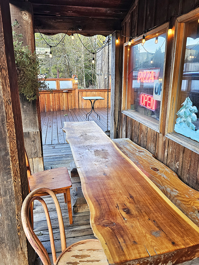 The stone fireplace stands like a silent guardian of coziness, promising warmth to hikers and skiers whose stories of adventure fuel the flames.