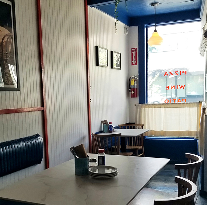 Simple tables, blue banquettes, and white walls create the perfect canvas for the real artwork: what's about to arrive on your plate.