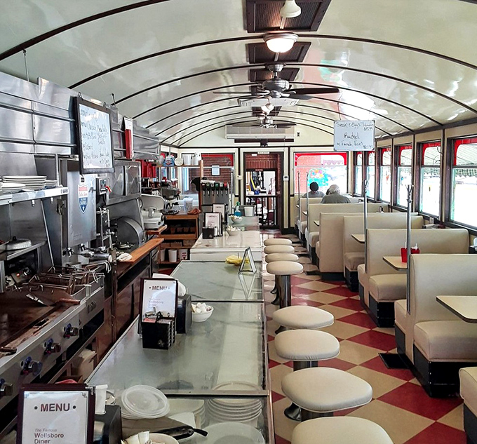 The curved ceiling and endless counter create a dining car experience that makes every meal feel like you're on a delicious journey through Americana.