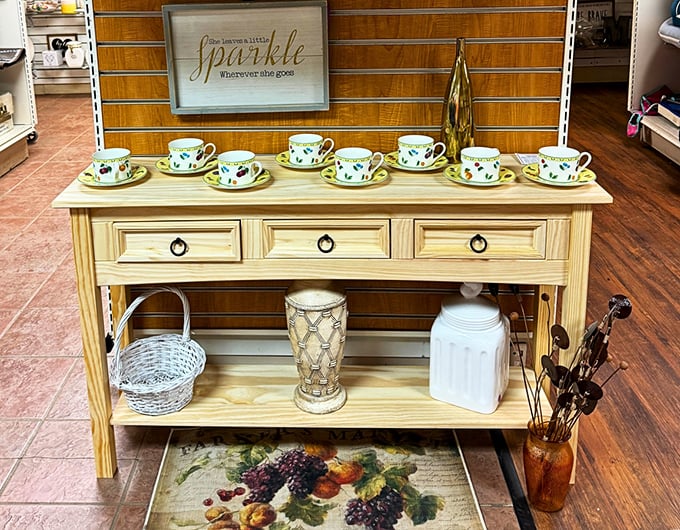Delicate teacups parade atop a country-chic console table, ready to transform ordinary afternoons into proper English tea experiences.