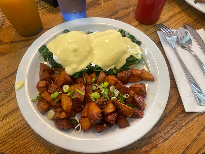 Eggs Benedict that makes you understand why people wait in line for breakfast&mdash;hollandaise sauce cascading over spinach like a savory waterfall.