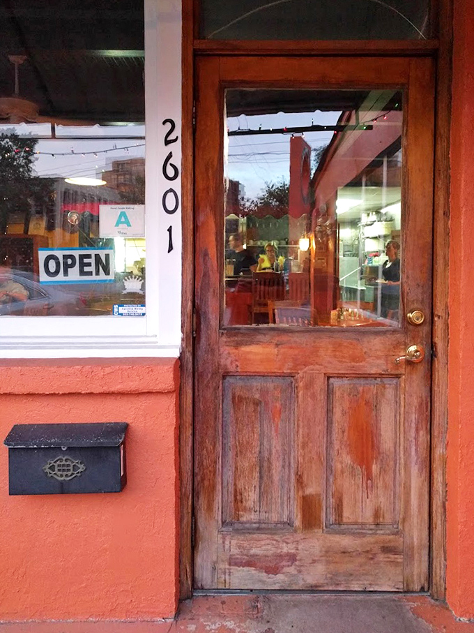 The weathered wooden door stands like a portal to flavor country. No velvet ropes or bouncers&mdash;just honest hospitality waiting inside.