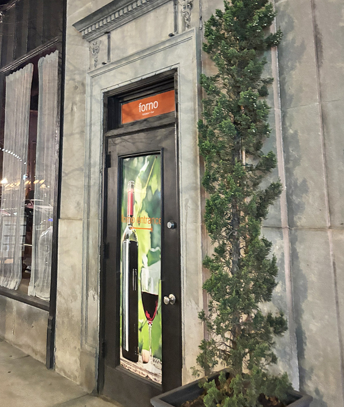 The entrance beckons with promises of wood-fired delights within. That sliver of greenery adds just the right touch of natural elegance.