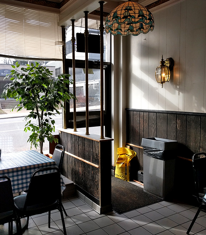Sunlight streams through the windows, illuminating a cozy corner where countless cheesesteak memories have been made over the decades.