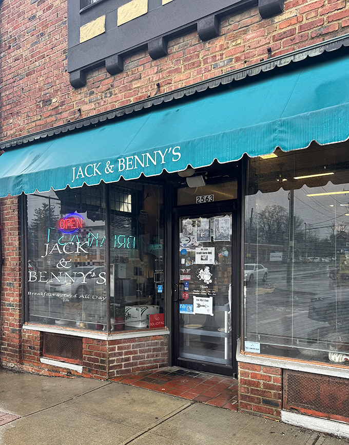 The teal awning signals breakfast paradise like a beacon for hungry travelers. This doorway has welcomed generations of Columbus residents.