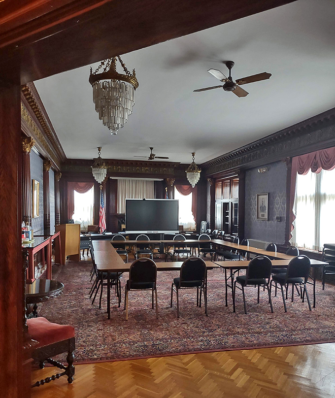 Crystal chandeliers and ornate moldings transform this meeting room into a space where even budget discussions feel positively aristocratic.