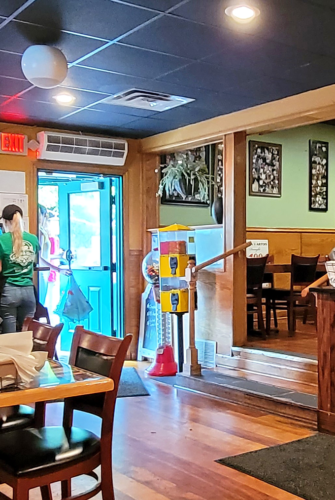 The entrance to the restrooms—because even burger pilgrims need a pit stop. That gumball machine is pure nostalgic genius.