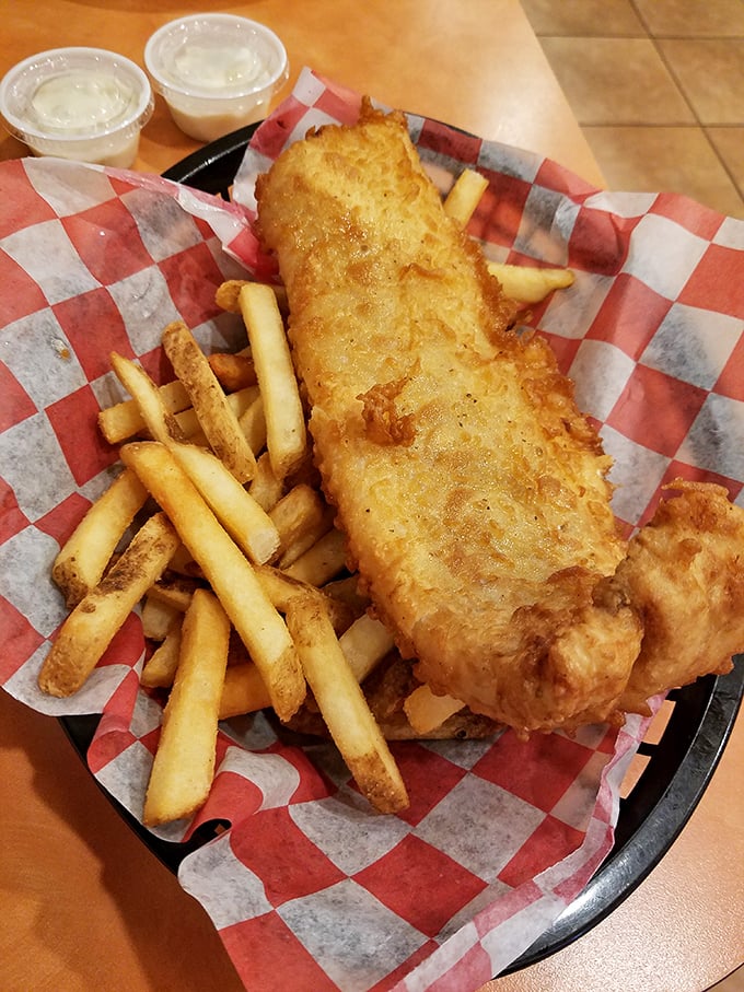 Fish and chips that would make a British pub-goer nod in approval, golden-battered and ready for a splash of malt vinegar.
