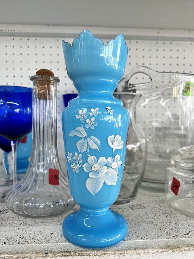 Vintage blue glass vase with delicate white flowers—grandmother-approved decor that's suddenly trendy again. Everything old becomes new eventually.