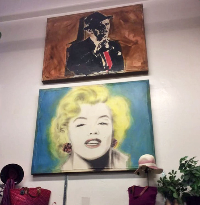 Pop art portraits watching over the merchandise like glamorous guardian angels of good taste and better deals.