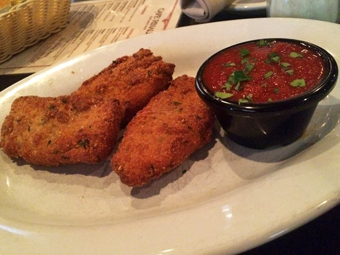 Fried risotto balls guarding their marinara companion&mdash;the crunch you hear now is the sound of willpower crumbling across Pennsylvania.