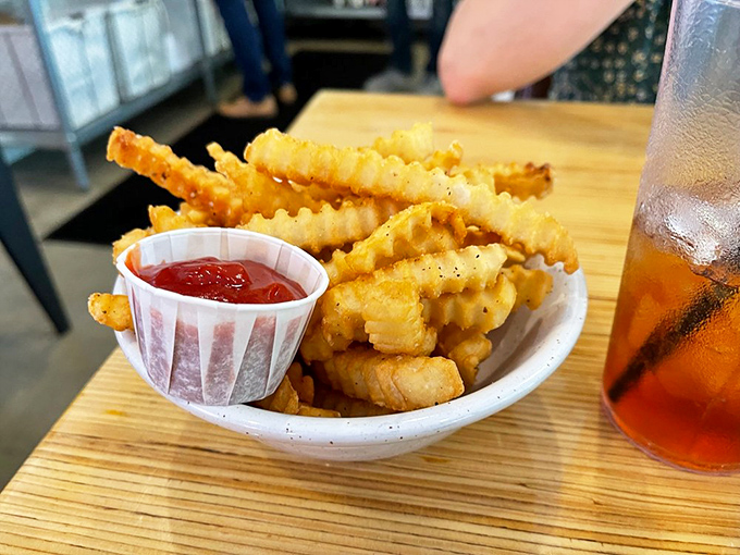 Crinkle-cut fries that achieve the golden trifecta: crispy exterior, fluffy interior, and just enough salt to make you reach for "just one more."
