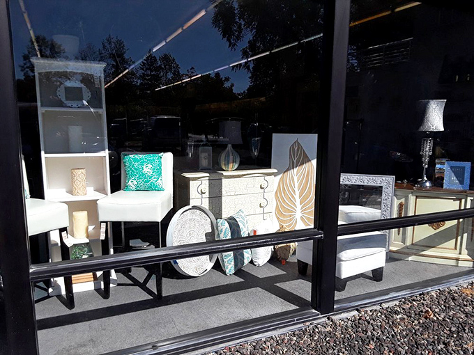 The furniture display window showcases pieces with potential&mdash;where mid-century meets modern meets "I could totally refinish that!"