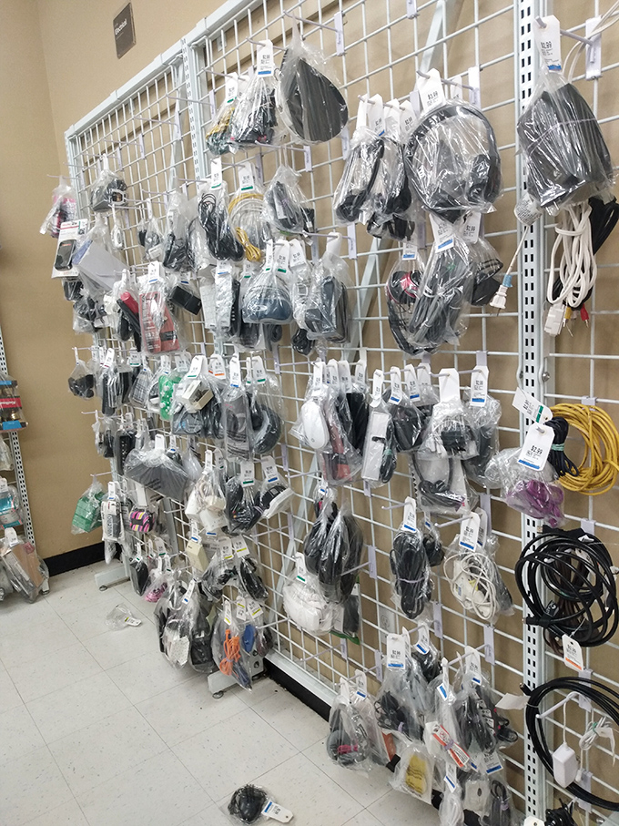 The wall of electronic accessories looks like a technological pasta dish, cords and cables tangled in organized chaos.