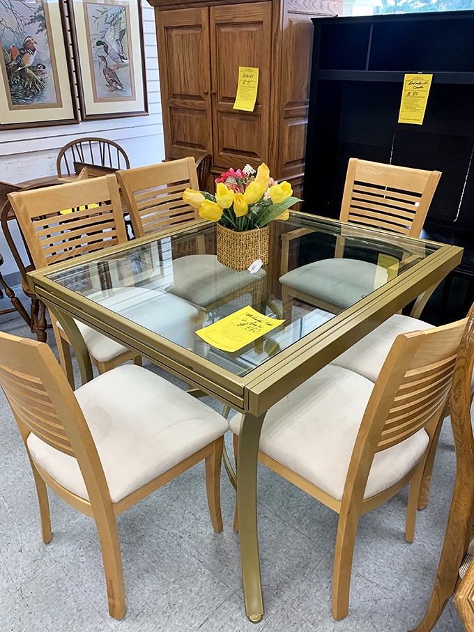A glass dining set that screams "adults live here," complete with chairs that won't collapse when your in-laws visit.