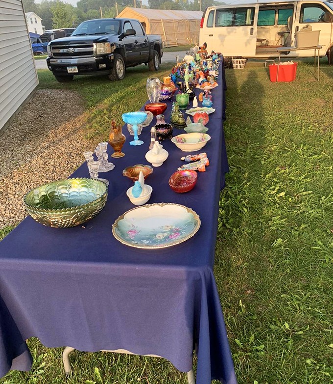 A royal procession of glassware marches down a humble table, Depression glass and hand-painted china awaiting their second act in new homes.