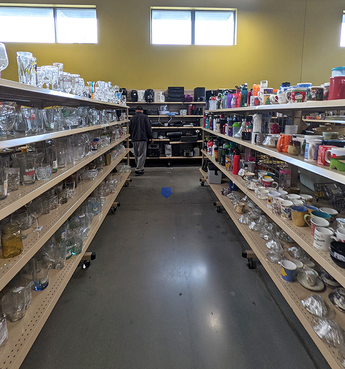 The glassware aisle sparkles with potential, where mismatched treasures await someone who appreciates eclectic dinner party charm.