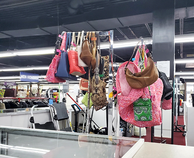 Handbag heaven hanging in plain sight. Designer lookalikes and genuine finds dangle like fashionable fruit ripe for the picking.