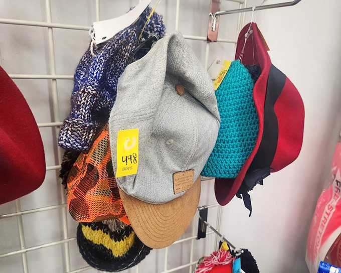 Hats with personality and history hang in colorful rows. That gray cap might have witnessed a ballgame or two before finding its way to your collection.