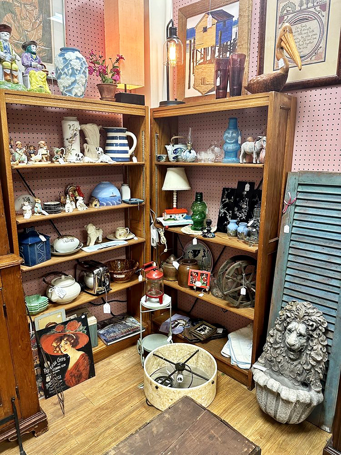 A treasure hunter's dream corner! Vintage ceramics, figurines, and that stone lion's head watching over it all like a regal guardian of forgotten memories.