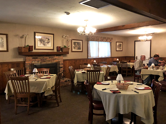This cozy dining area with its brick fireplace feels like dinner at a friend's ranch house&mdash;if your friend happened to be a steak-grilling savant.