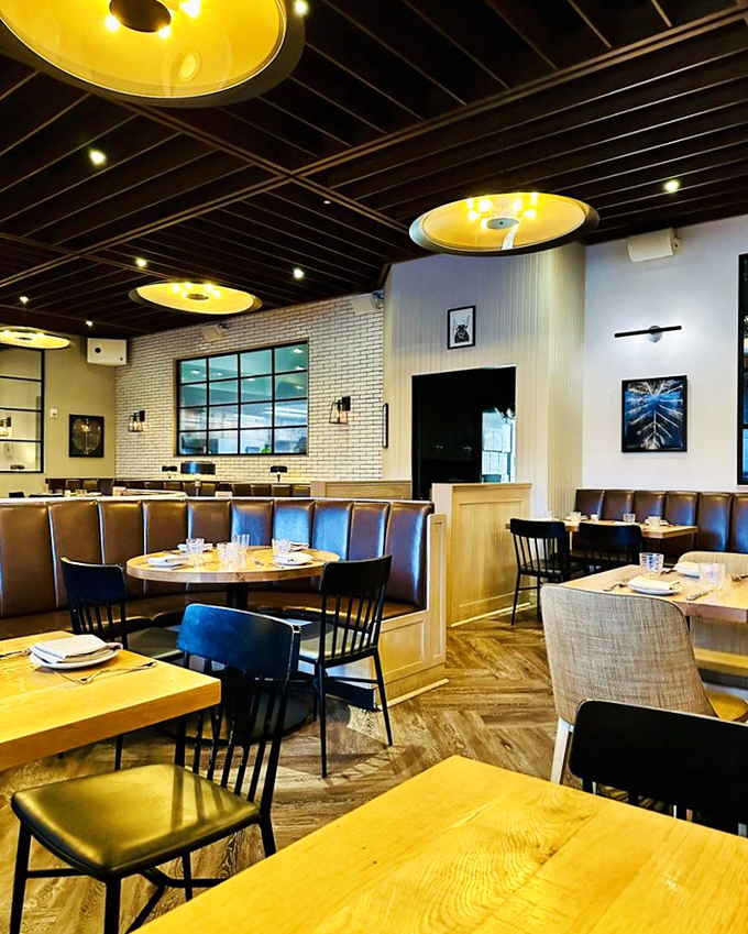 Light wood, leather seating, and those signature golden lights create a space where "just one more bite" becomes the evening's mantra.