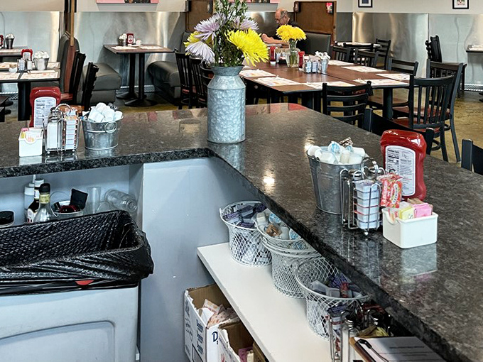 Fresh flowers in metal containers add homey touches to the counter area &ndash; small details that make a big difference.