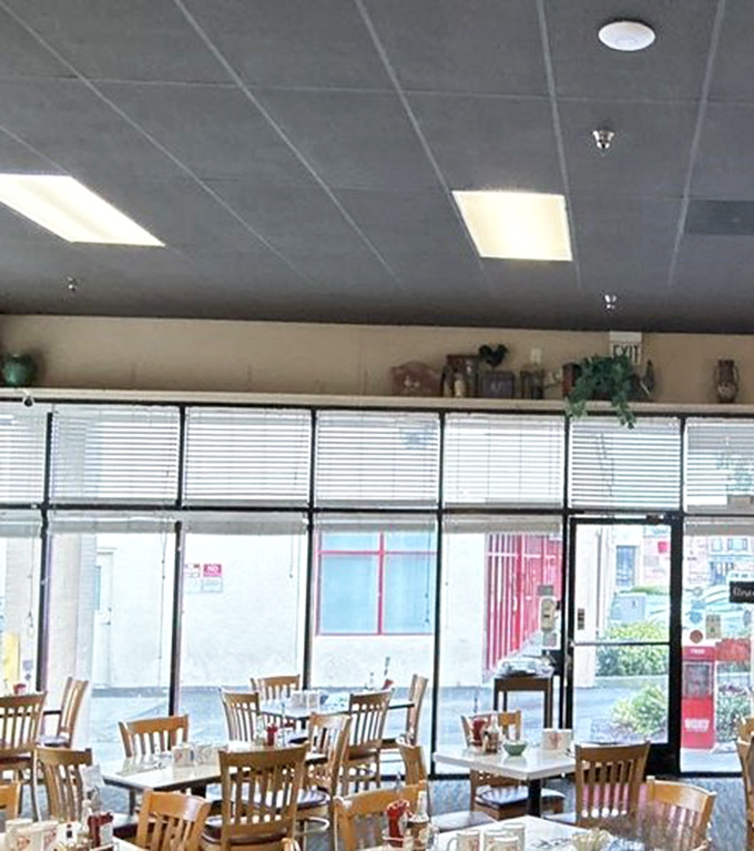 Sunlight streams through windows, illuminating tables awaiting their next hungry visitors. The calm before the breakfast storm.