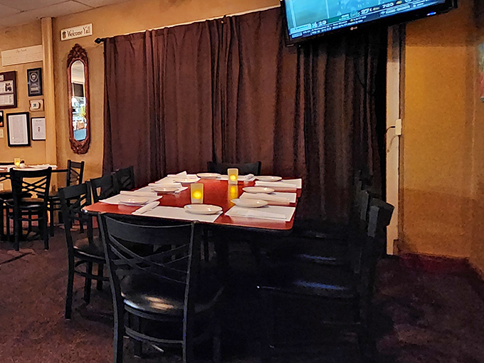 The dining room balances casual comfort with just enough elegance. Those dark wood chairs have supported countless happy diners in their culinary journeys.