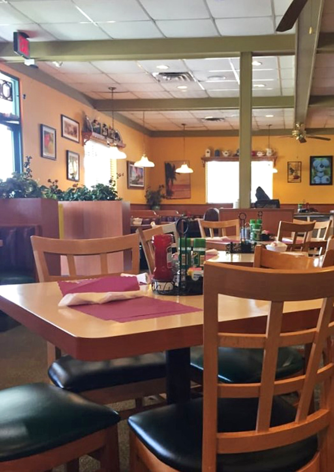 Warm yellow walls and wooden chairs create that classic diner feel. The kind of place where breakfast conversations solve most of life's problems.