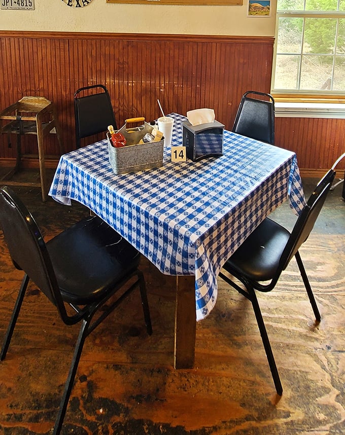 Blue checkered tablecloths and galvanized condiment caddies &ndash; dining room details that whisper "authentic" without trying too hard.