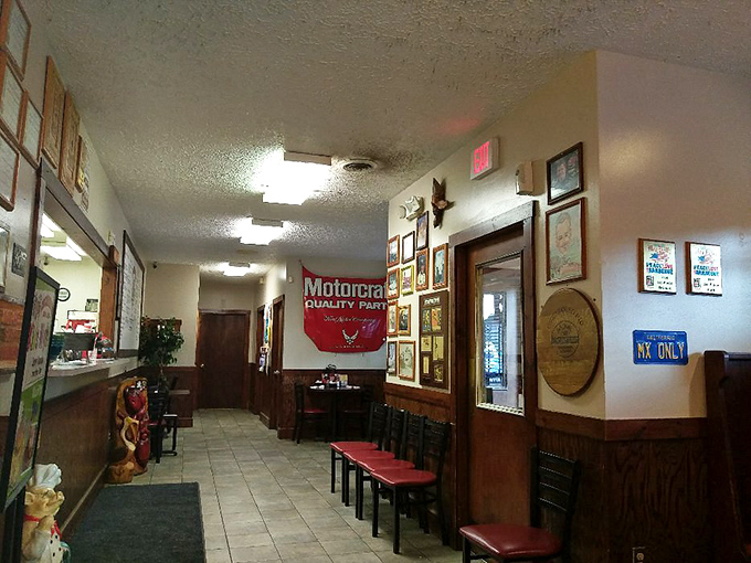 Wood paneling and racing flags tell you you're in Virginia without saying a word. The walls showcase decades of barbecue and motorsport heritage. 